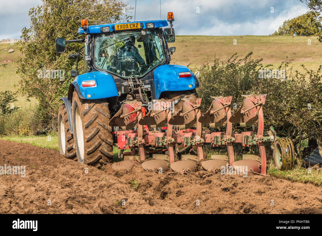A New Holland tractor and plough at work in autumn sunshine Stock Photo ...