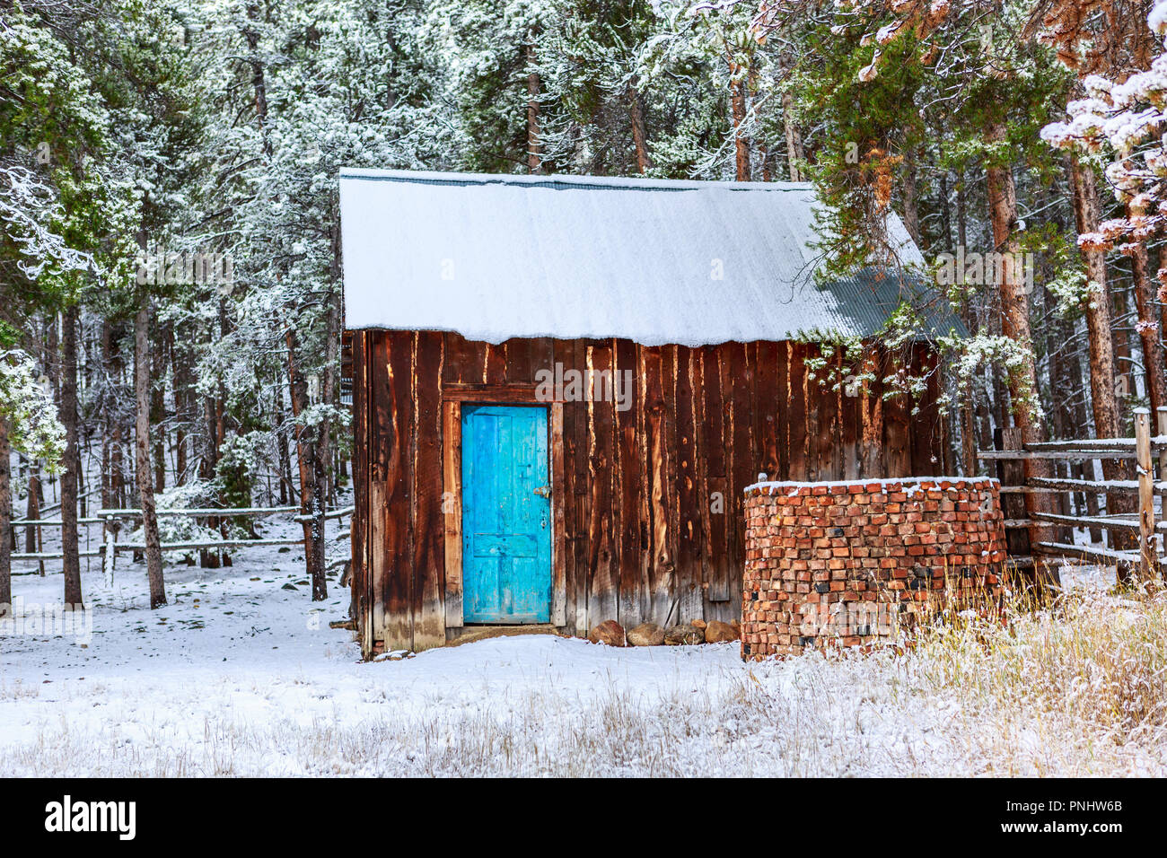 Blue door on a pump house with a brick cistern Stock Photo - Alamy