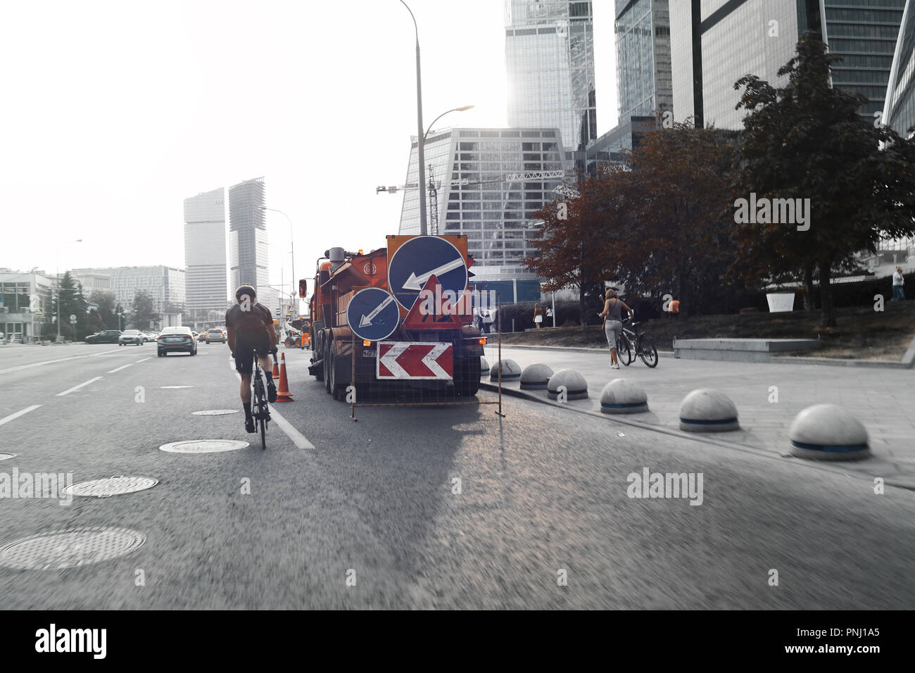 Man riding on bike town center hi-res stock photography and images - Alamy