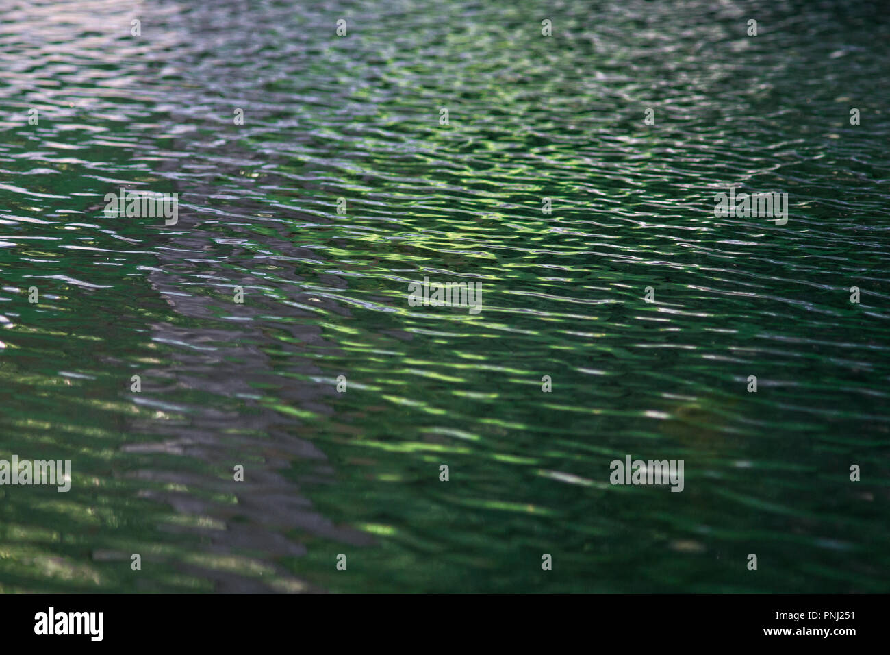Water texture or background. Colorful reflections. Play of light and ...