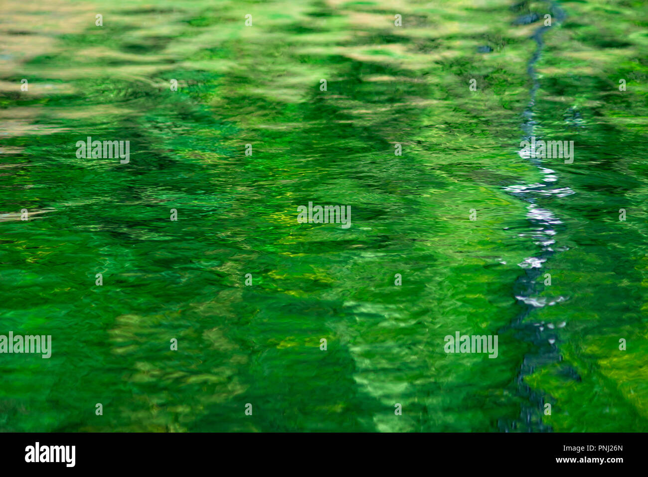 Water texture or background. Colorful reflections. Play of light and ...