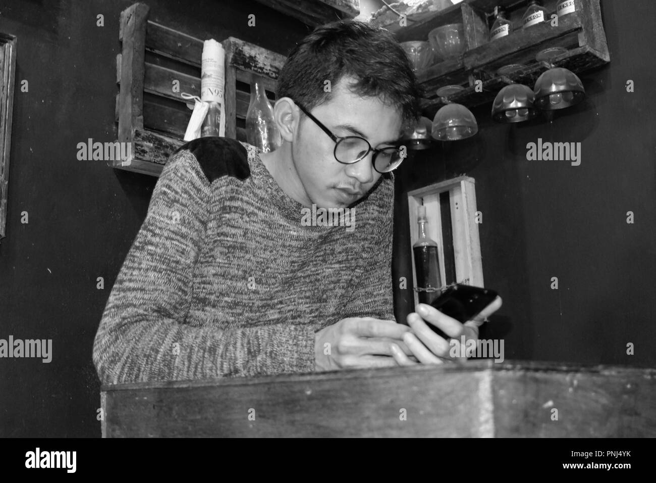 Man looking phone in Black and White Stock Photos & Images - Alamy