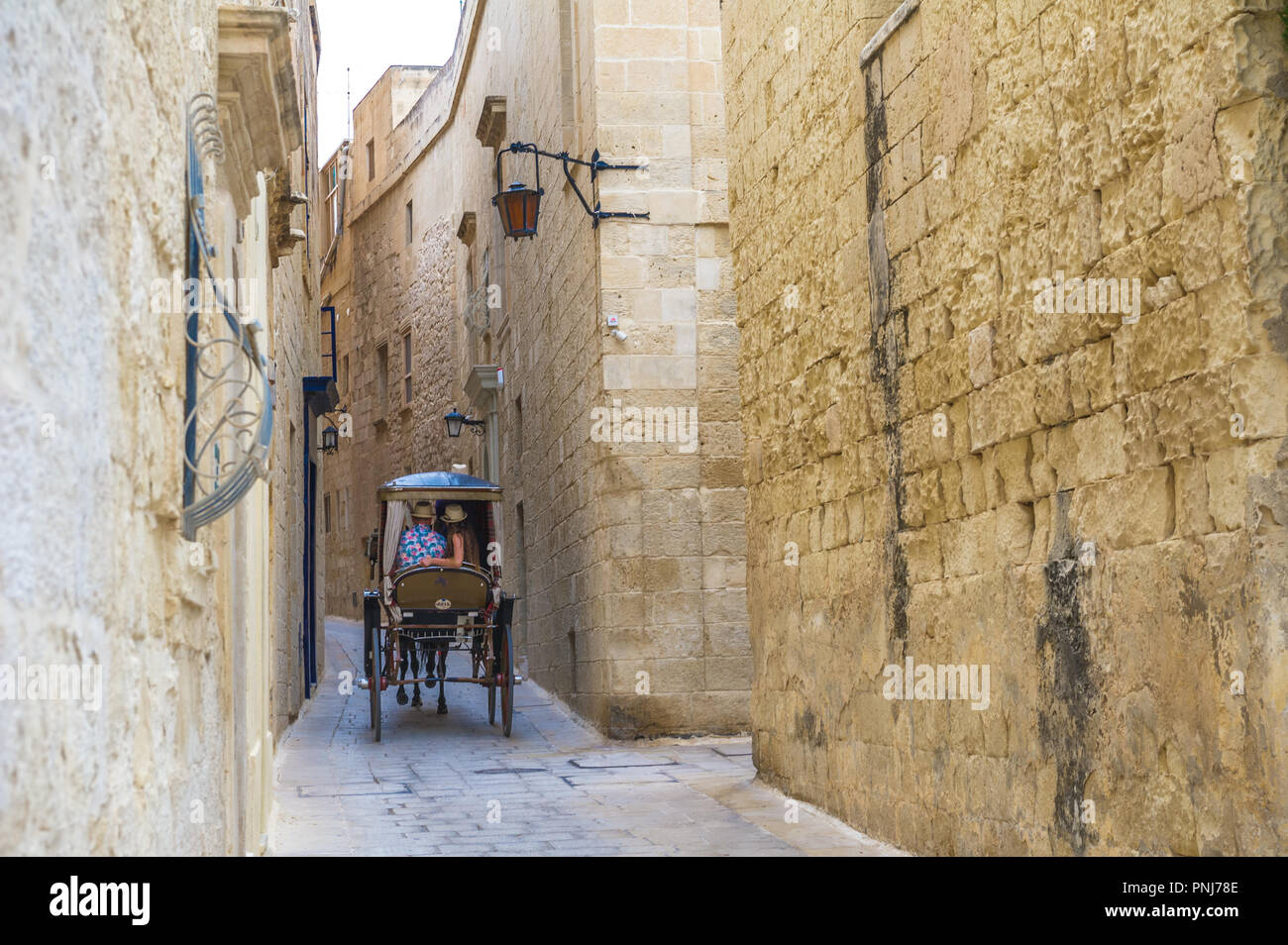 Horse-drawn carriage (karozzin) negotiate the narrow lanes of Mdina ...