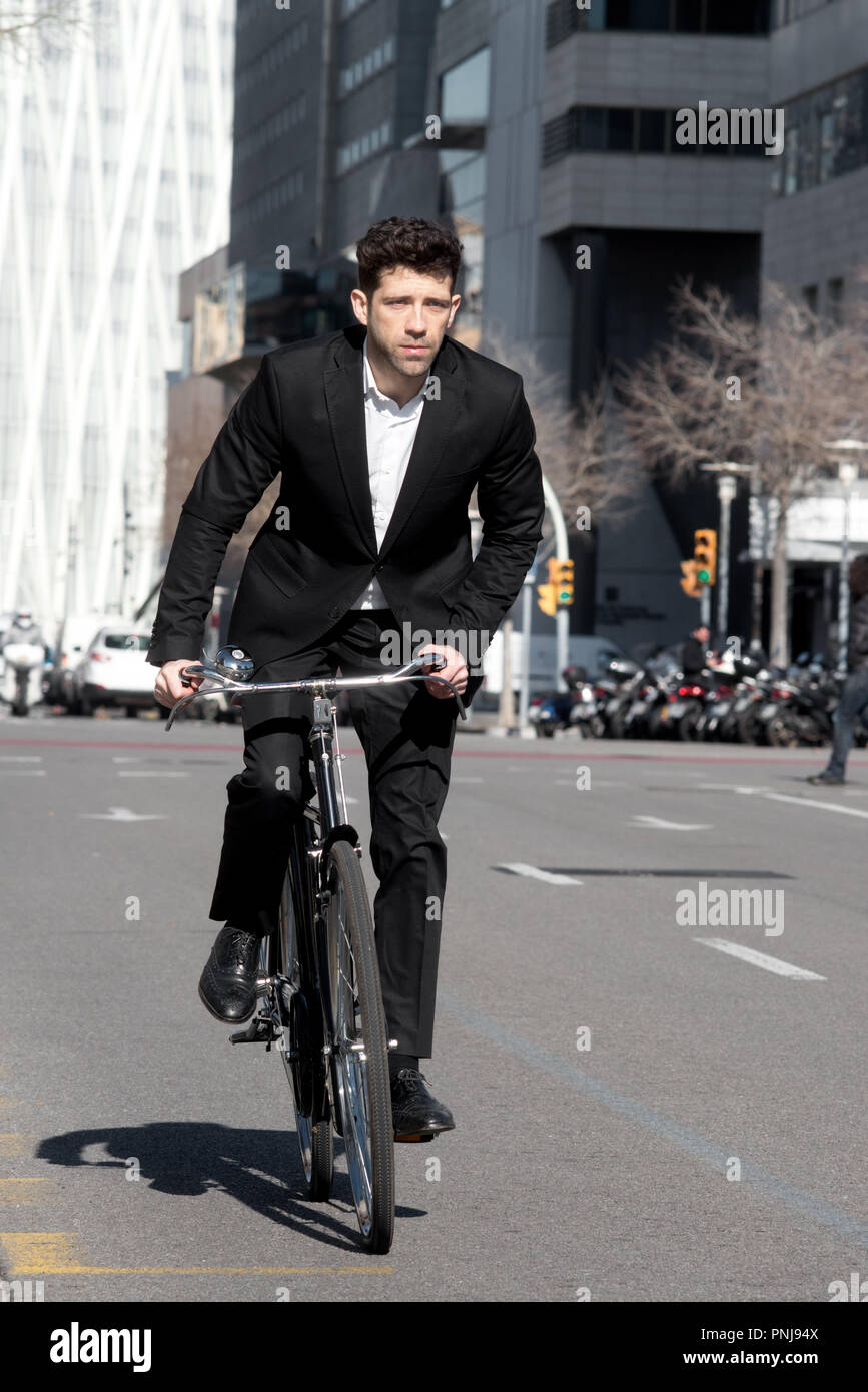 Man cycling around town Stock Photo - Alamy