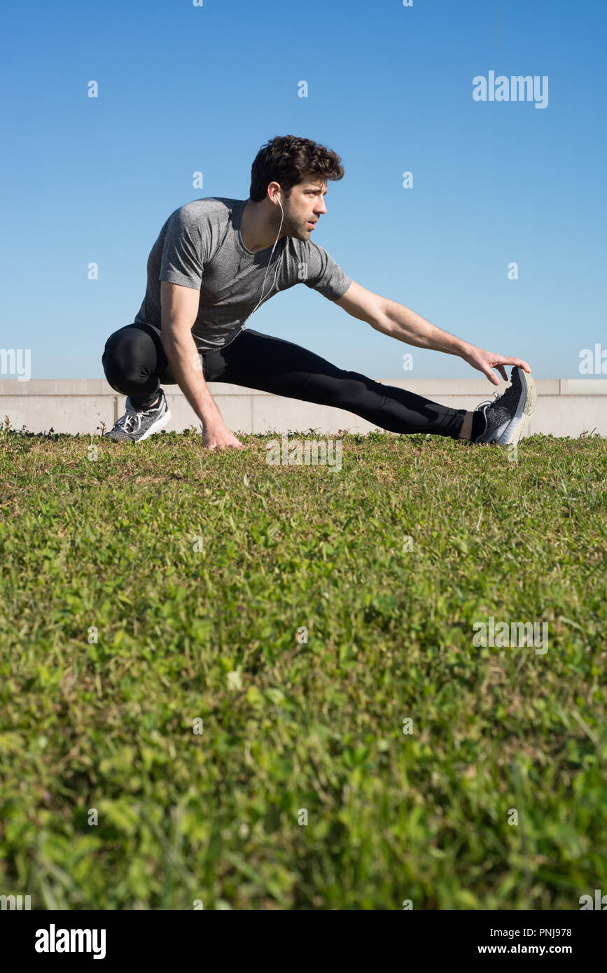 Athlete stretching in grass hi-res stock photography and images - Alamy