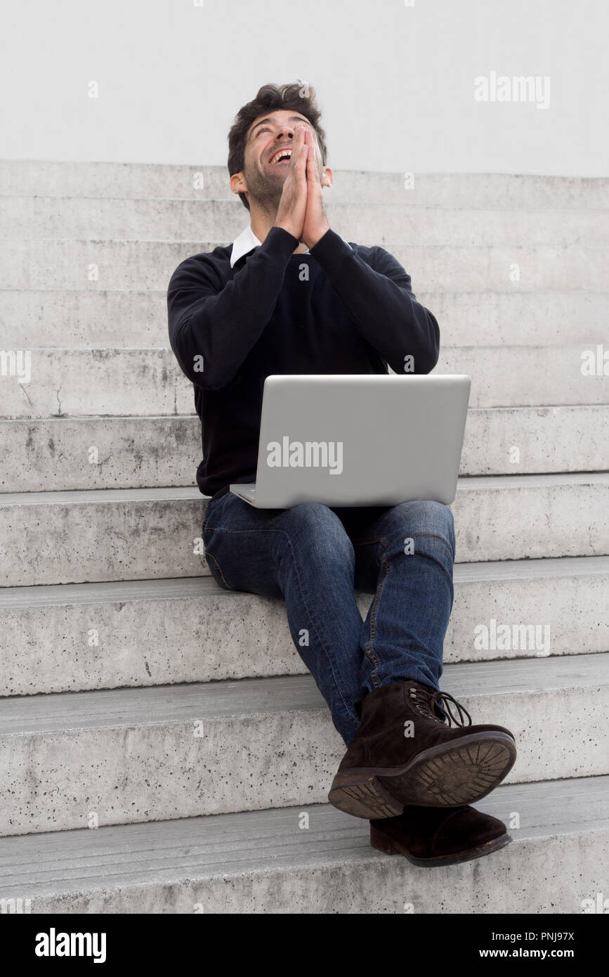 Winning young man with computer Stock Photo - Alamy