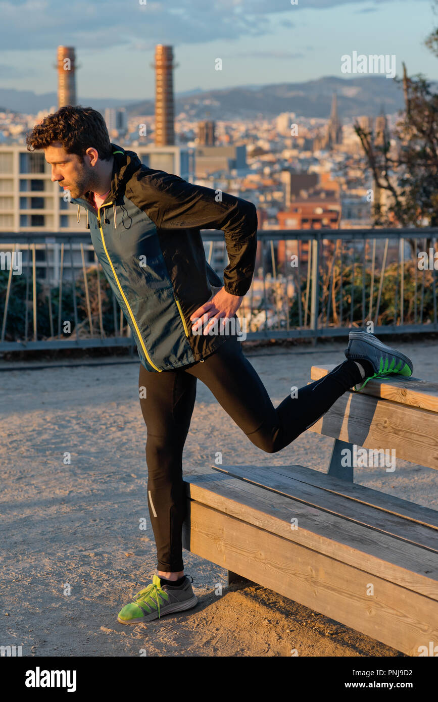 runner stretching leg on the table Stock Photo - Alamy