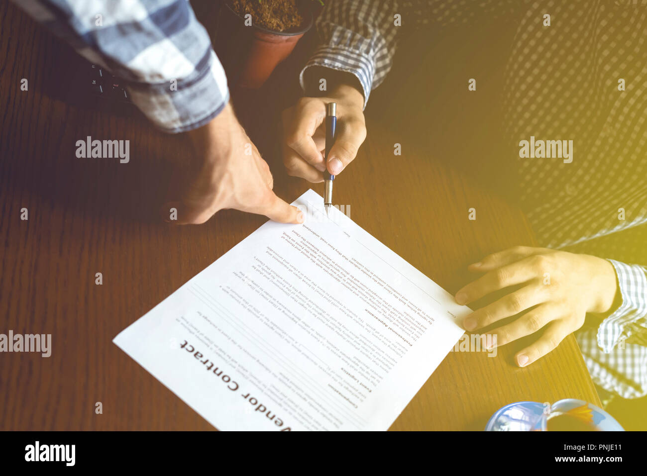 close up hand sign vendor contract on the table for the new house ...