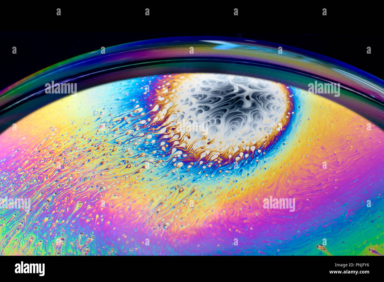 Detail of a soap bubble, looking like a colorful and fascinating planet ...