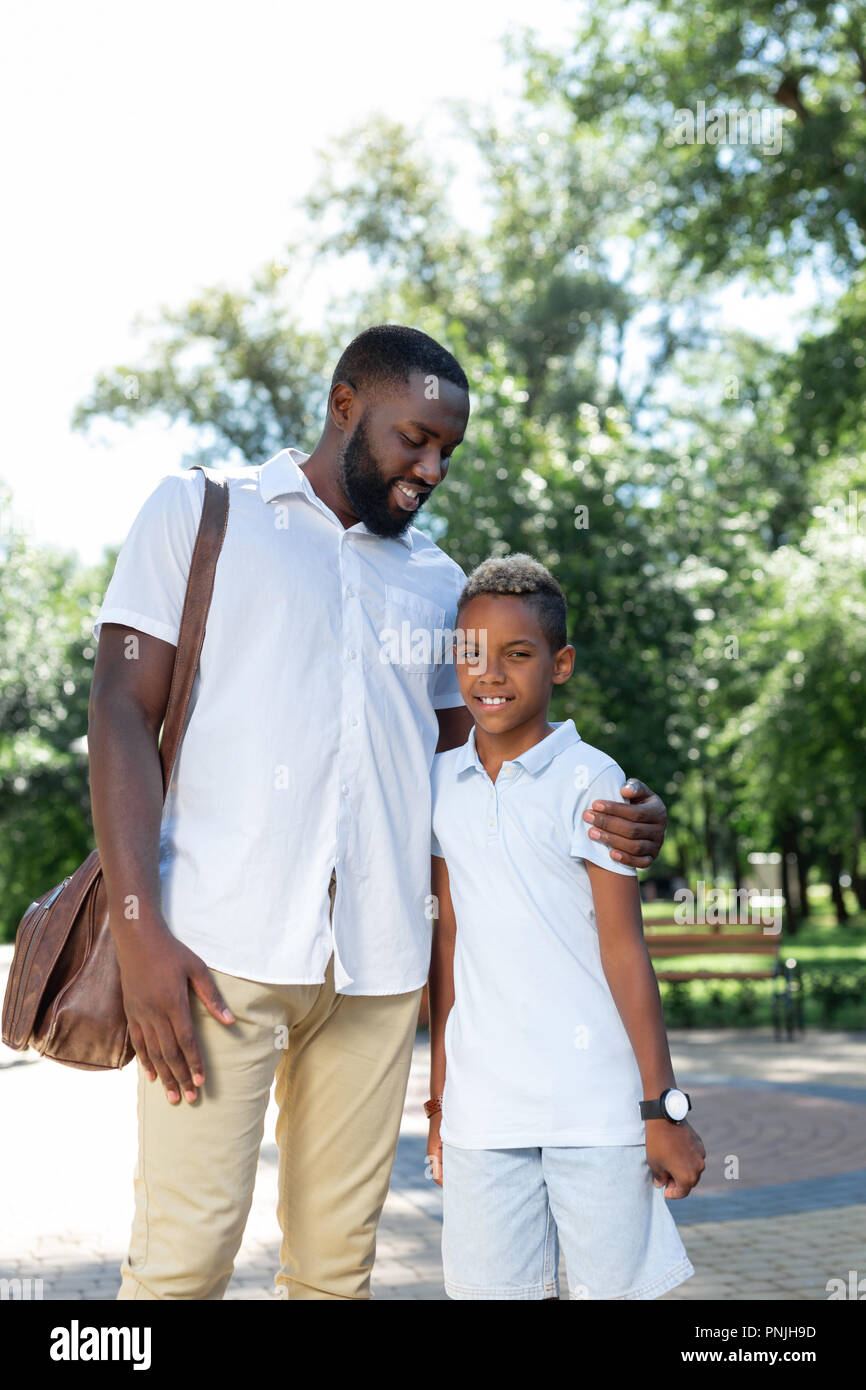 Joyful handsome father standing with his son Stock Photo - Alamy