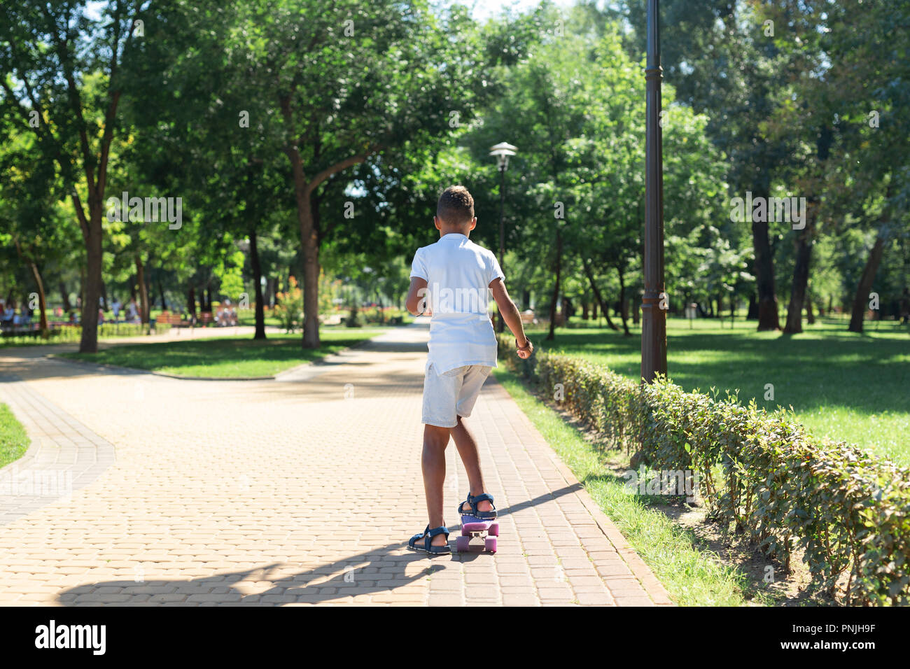 Nice happy active boy riding a skateboard Stock Photo - Alamy