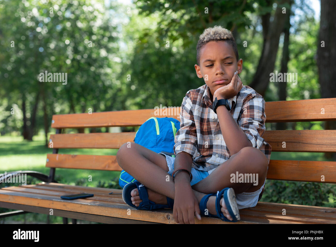 Pleasant nice young boy feeling very bored Stock Photo - Alamy