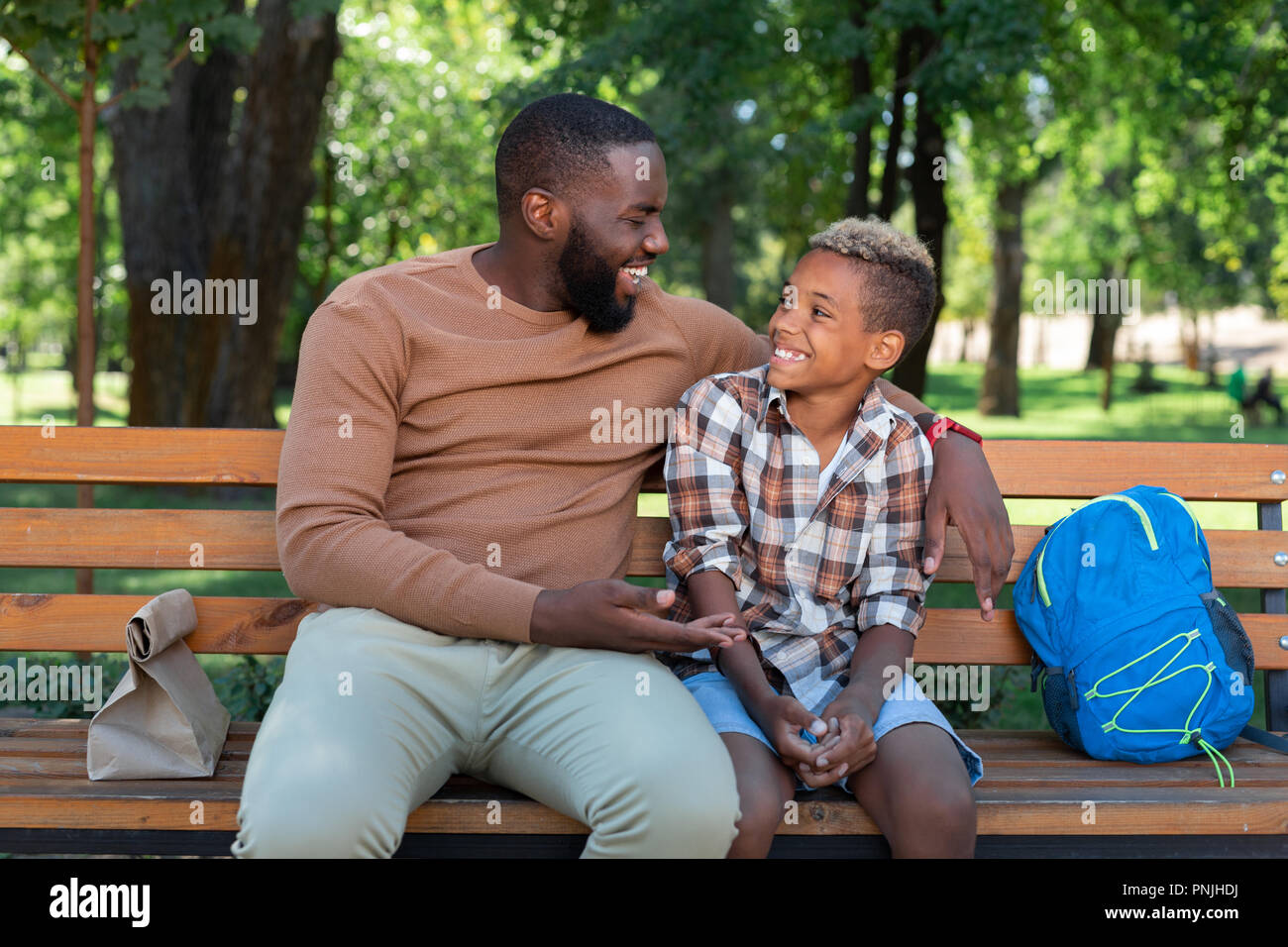 Nice positive man talking to his son Stock Photo - Alamy