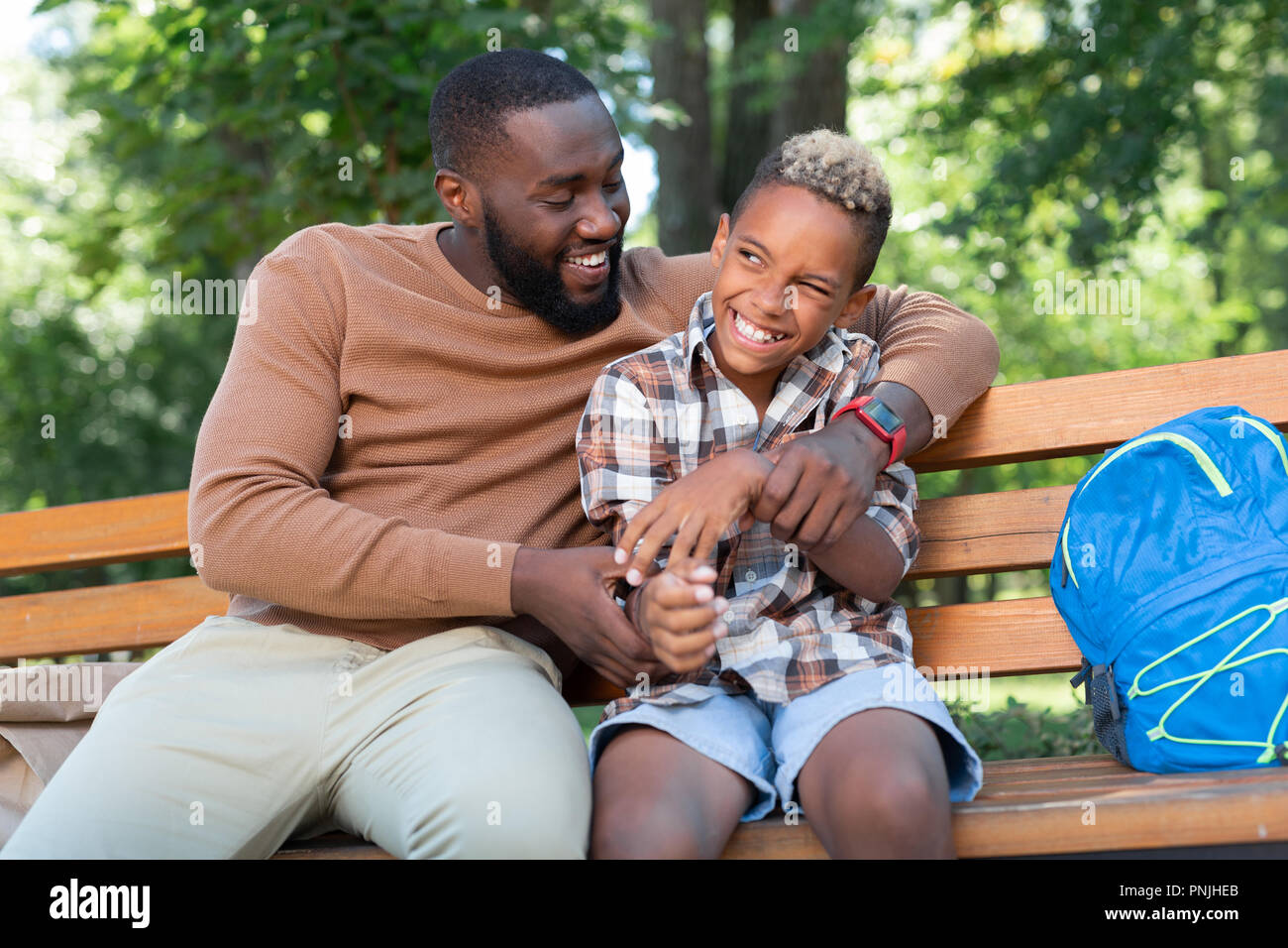 Joyful happy father and son resting together Stock Photo - Alamy