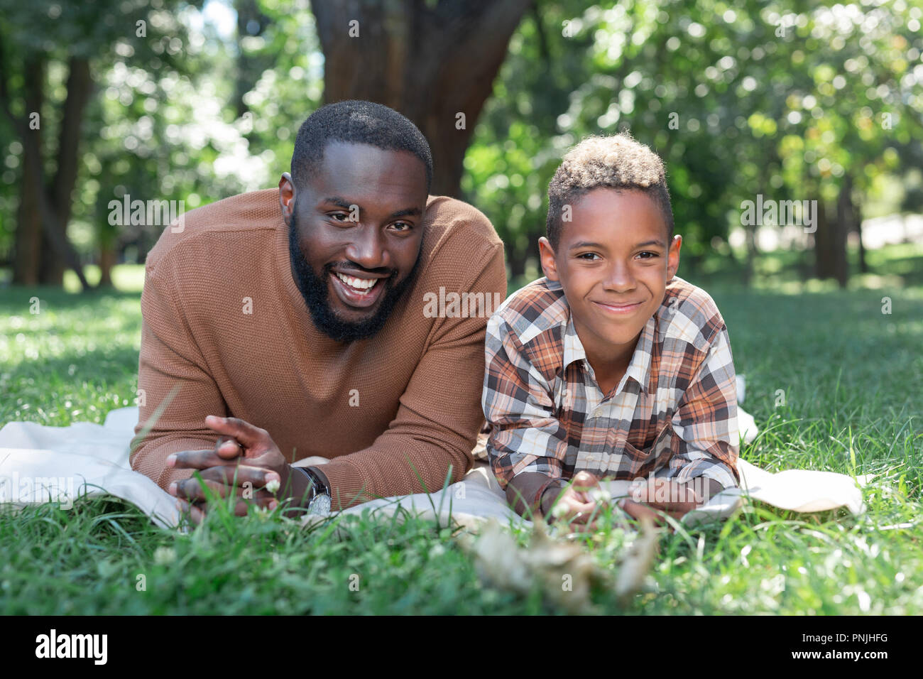 Joyful happy father and son looking at you Stock Photo - Alamy