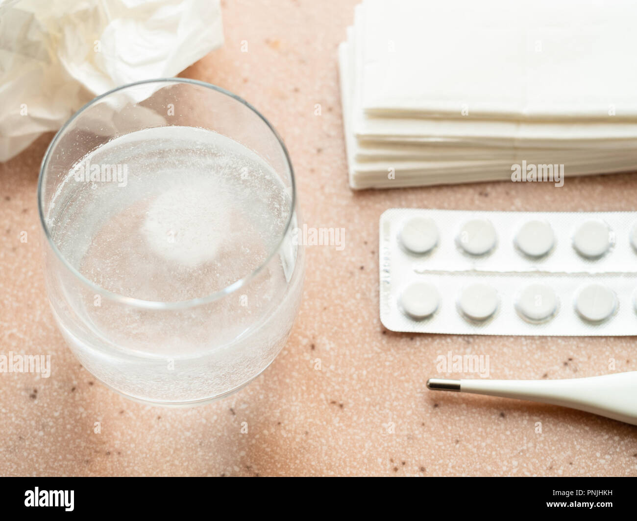 above view of glass of water with soluble tablet and set of medical ...