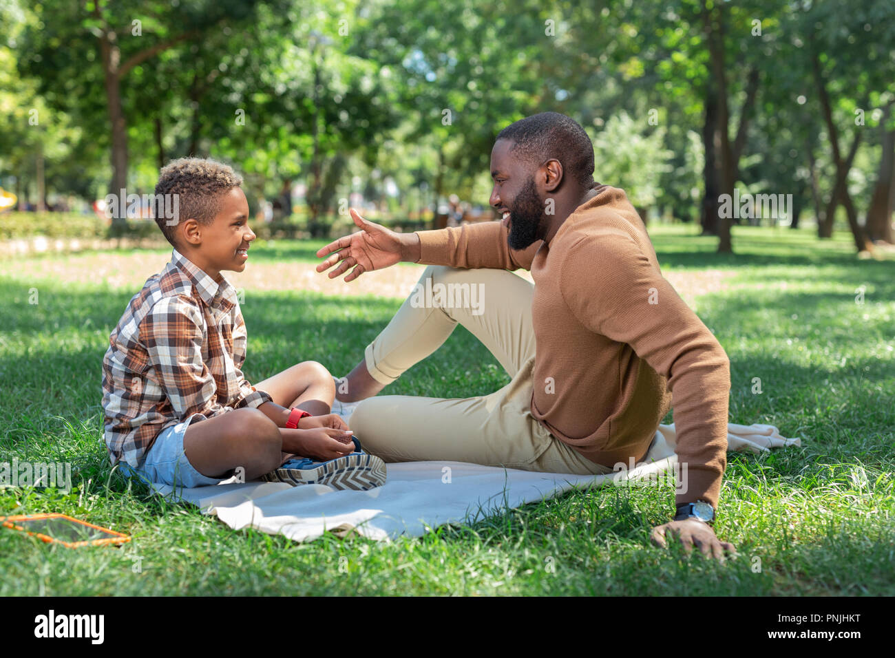 Happy cute son listening to his dad Stock Photo - Alamy