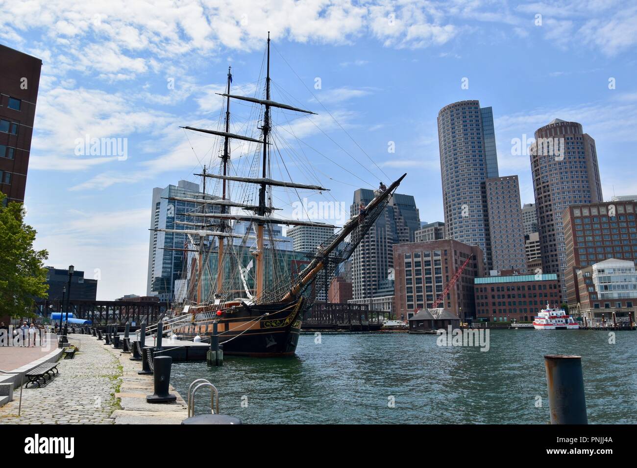 A sailing ship in Boston Harbor against the downtown skyline as seen ...