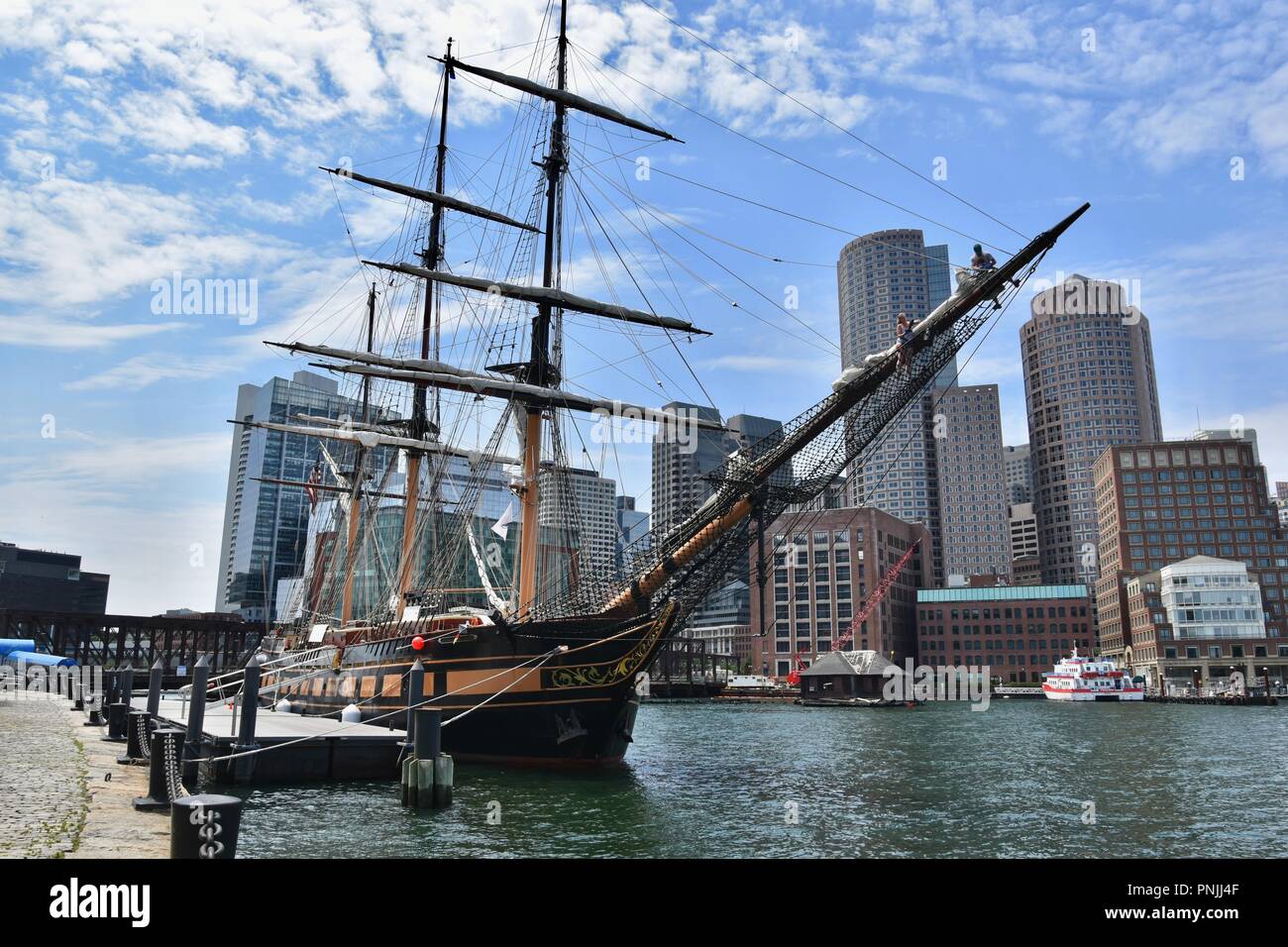 A sailing ship in Boston Harbor against the downtown skyline as seen ...