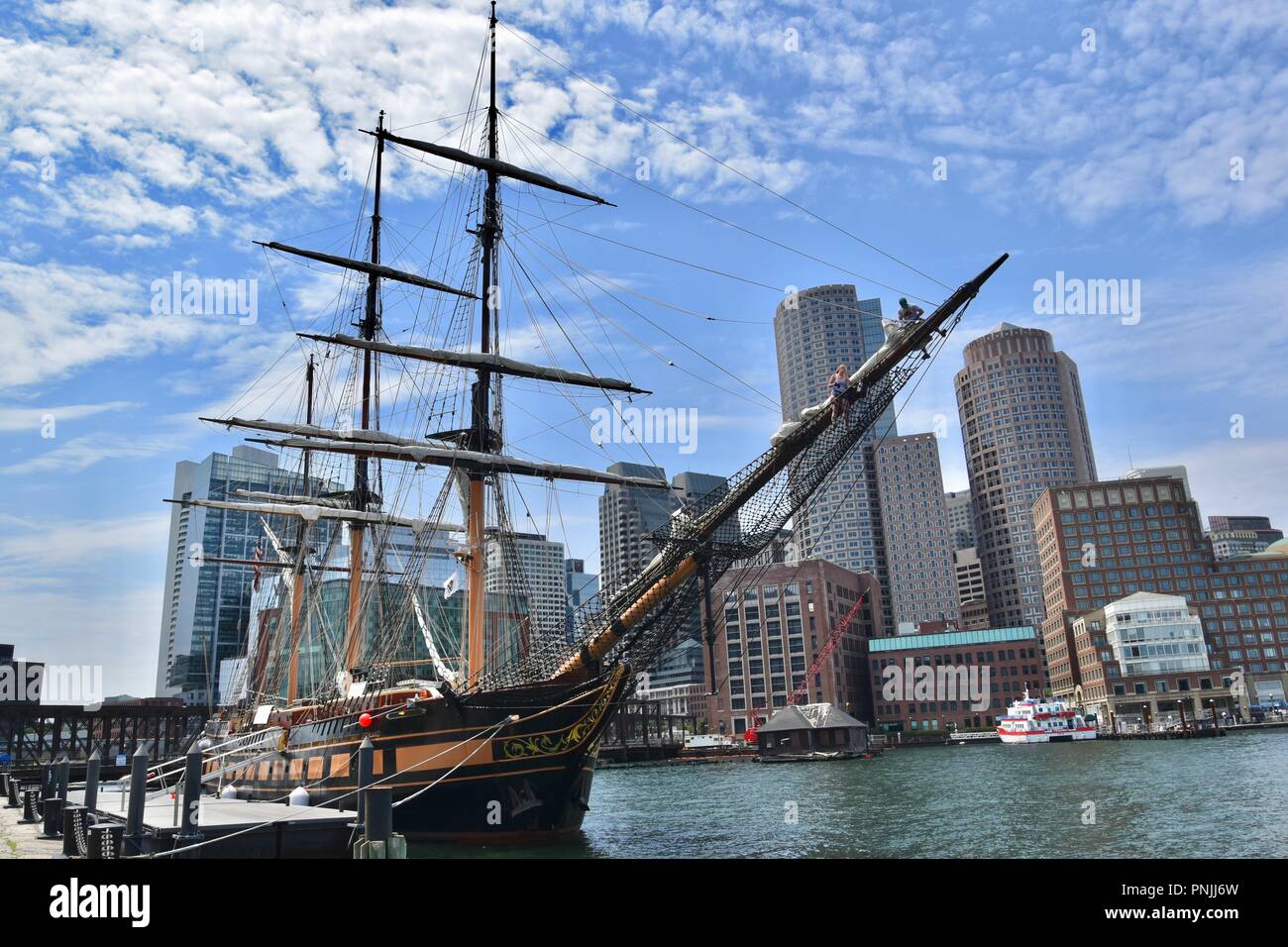 A sailing ship in Boston Harbor against the downtown skyline as seen ...
