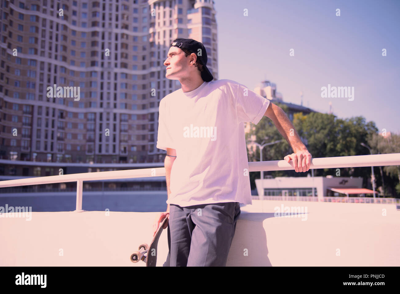 Attentive male person looking upwards on sky Stock Photo - Alamy