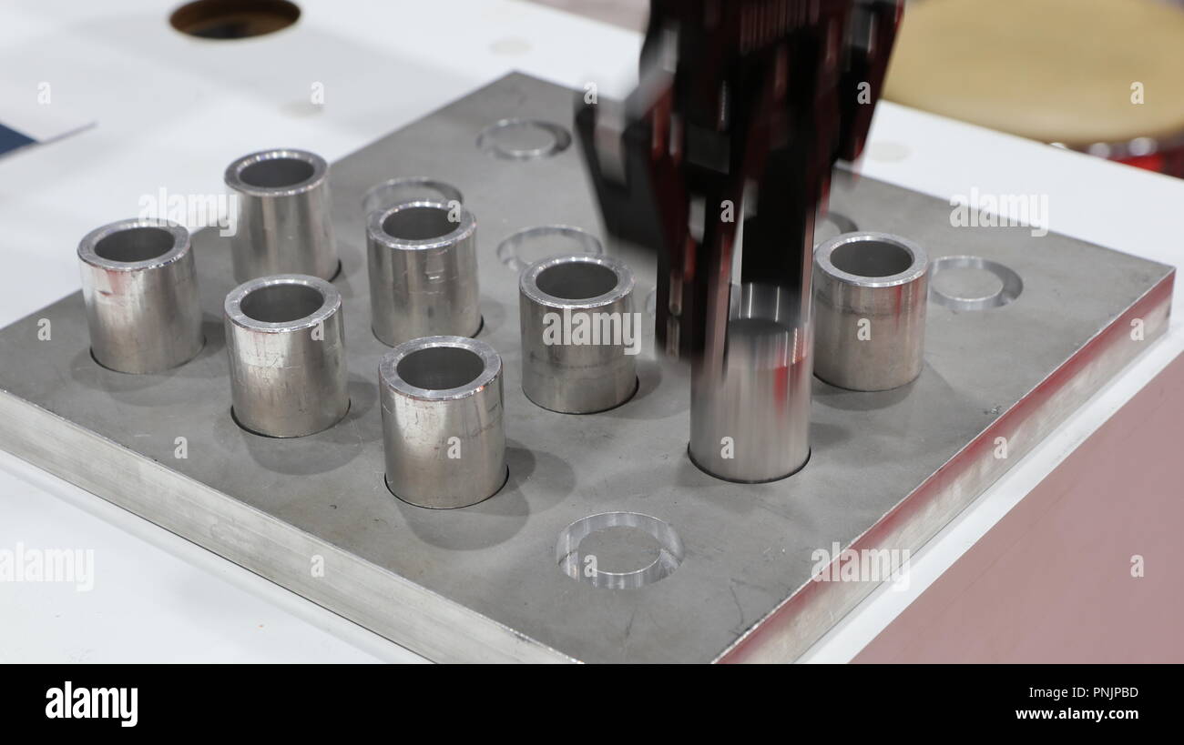 Robotic arm clamp sample and transfer in metal plate ;blurred image ...