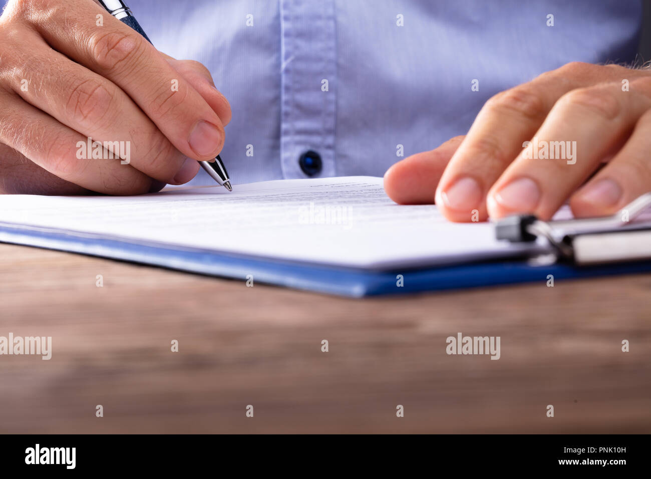 Men at a table signing papers hi-res stock photography and images - Alamy