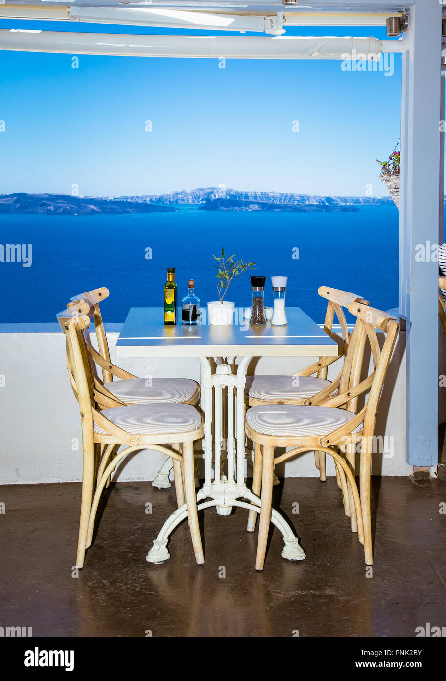 Table for dinner in traditional Greek restaurant with view on Santorini ...