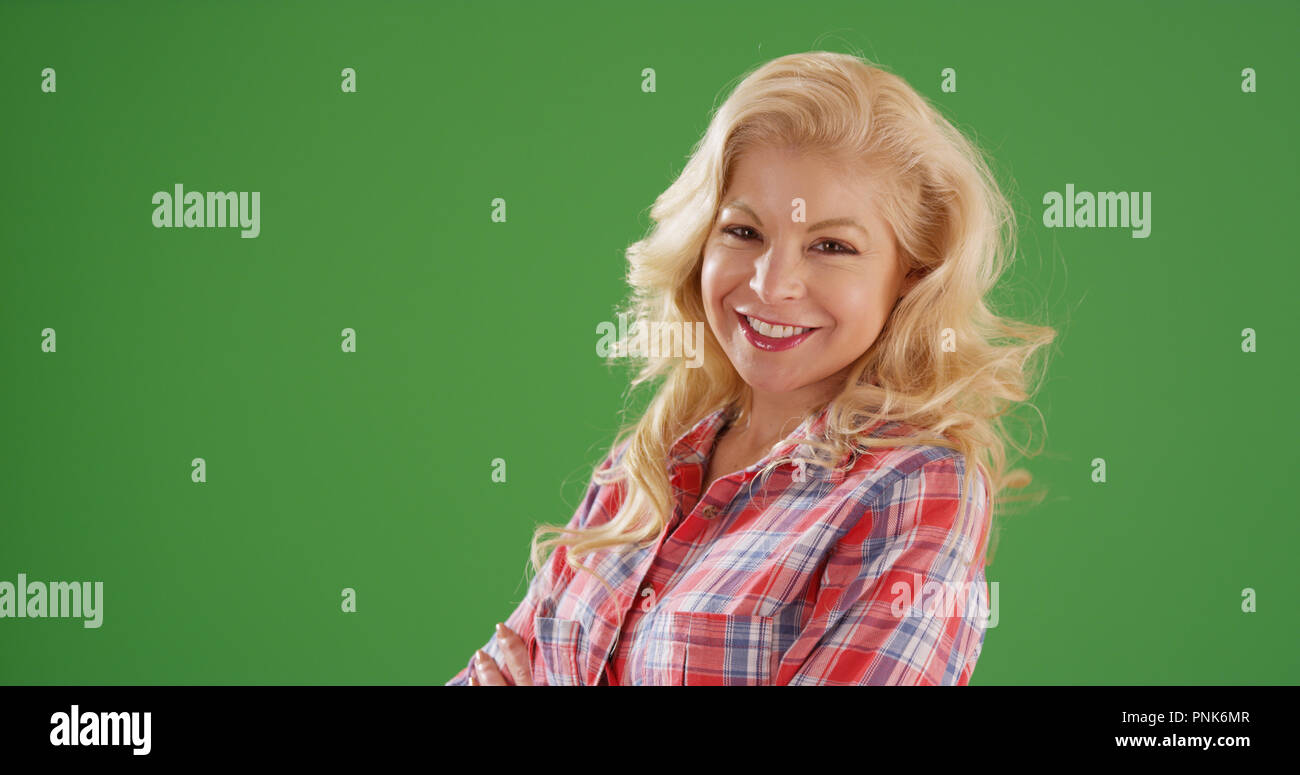 Happy Caucasian woman smiling at camera wearing plaid on green screen ...