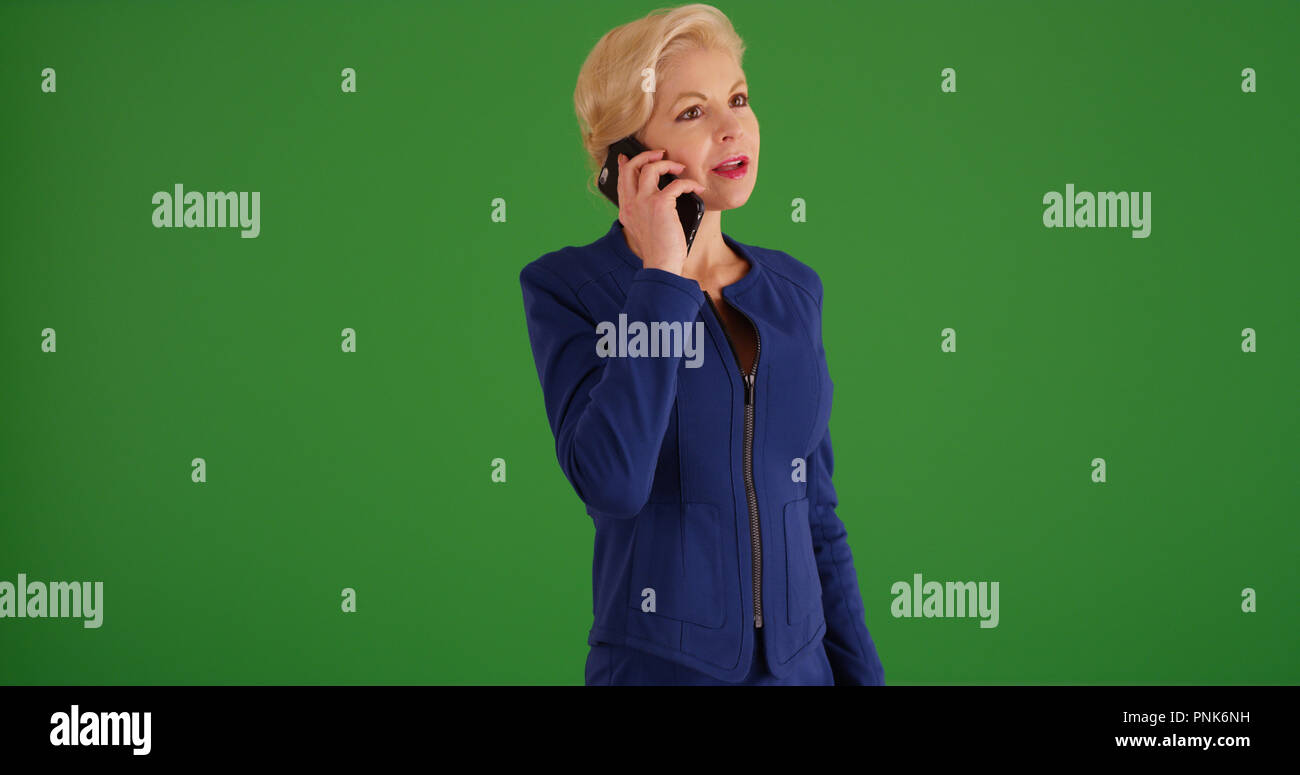 Professional white businesswoman making phone call on green screen ...
