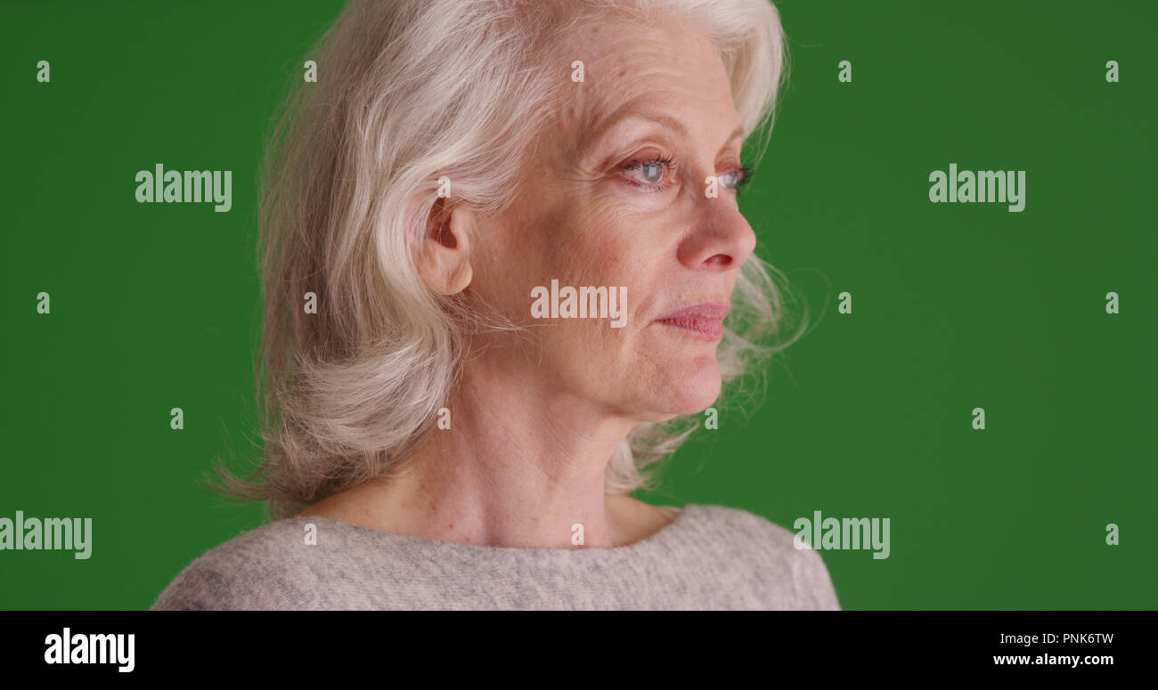 Old white lady deep in though looking off screen on green screen Stock ...