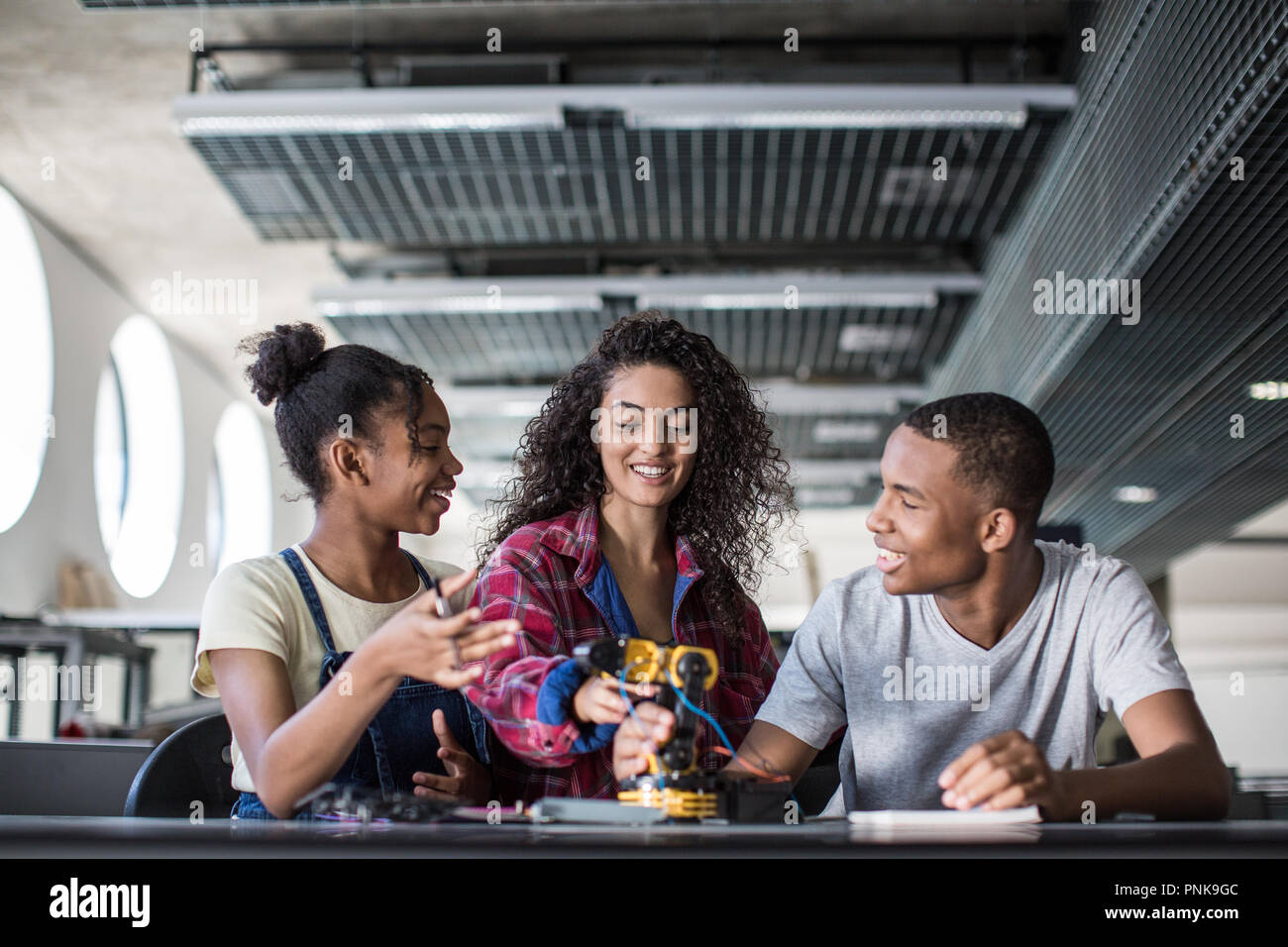 High school students working on a robotic arm in class Stock Photo - Alamy