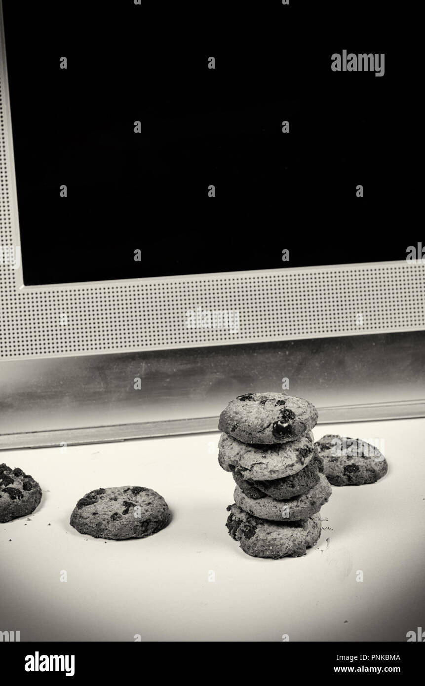 Cookies in front of a computer, a concept Stock Photo - Alamy