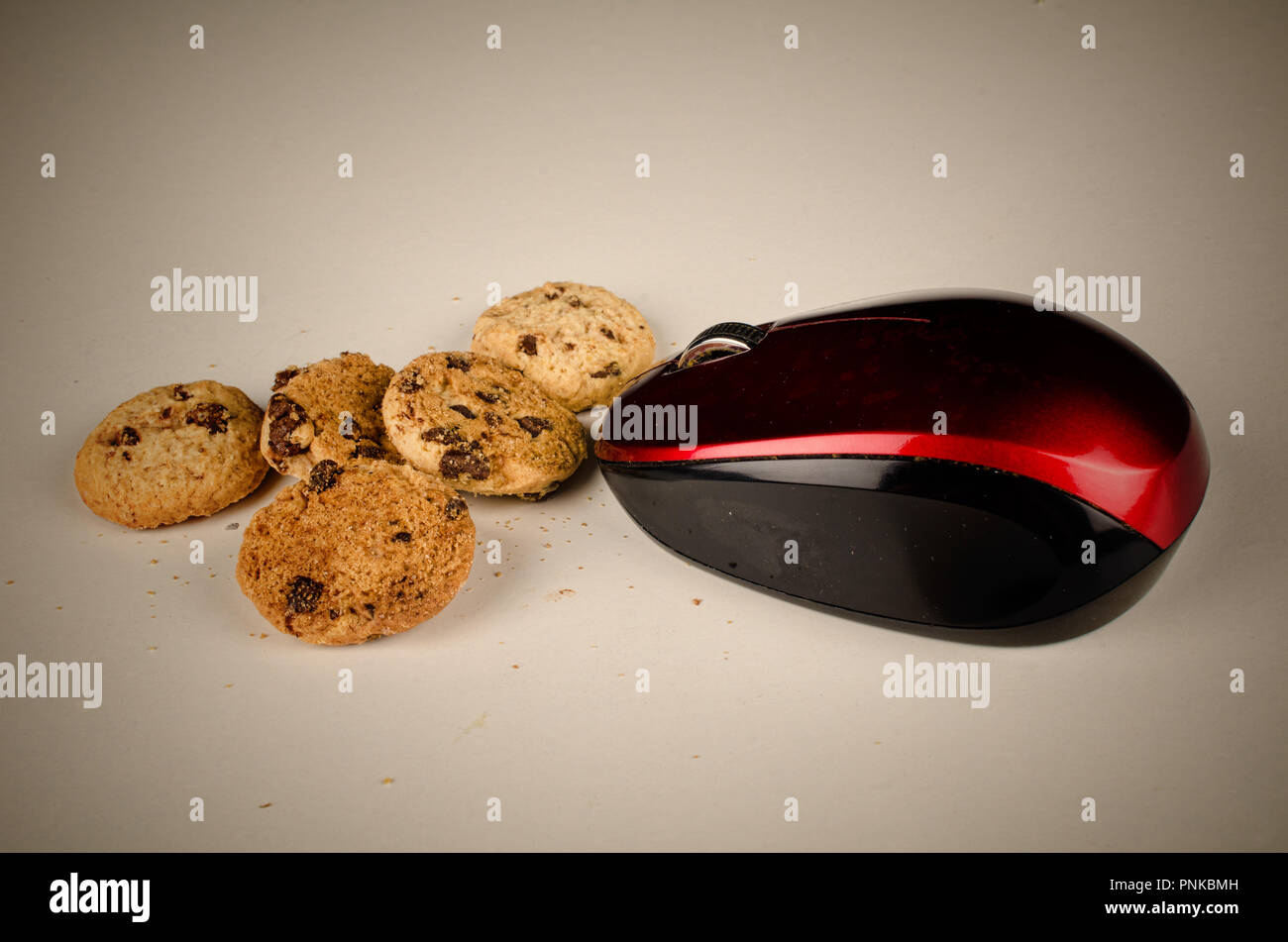 Mouse eating cookies, a funny technology concept Stock Photo - Alamy