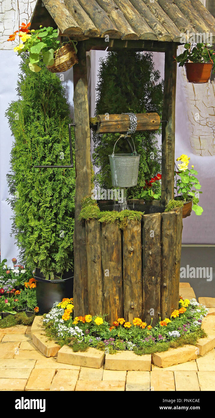 Old Style Wooden Water Well With Bucket Stock Photo - Alamy