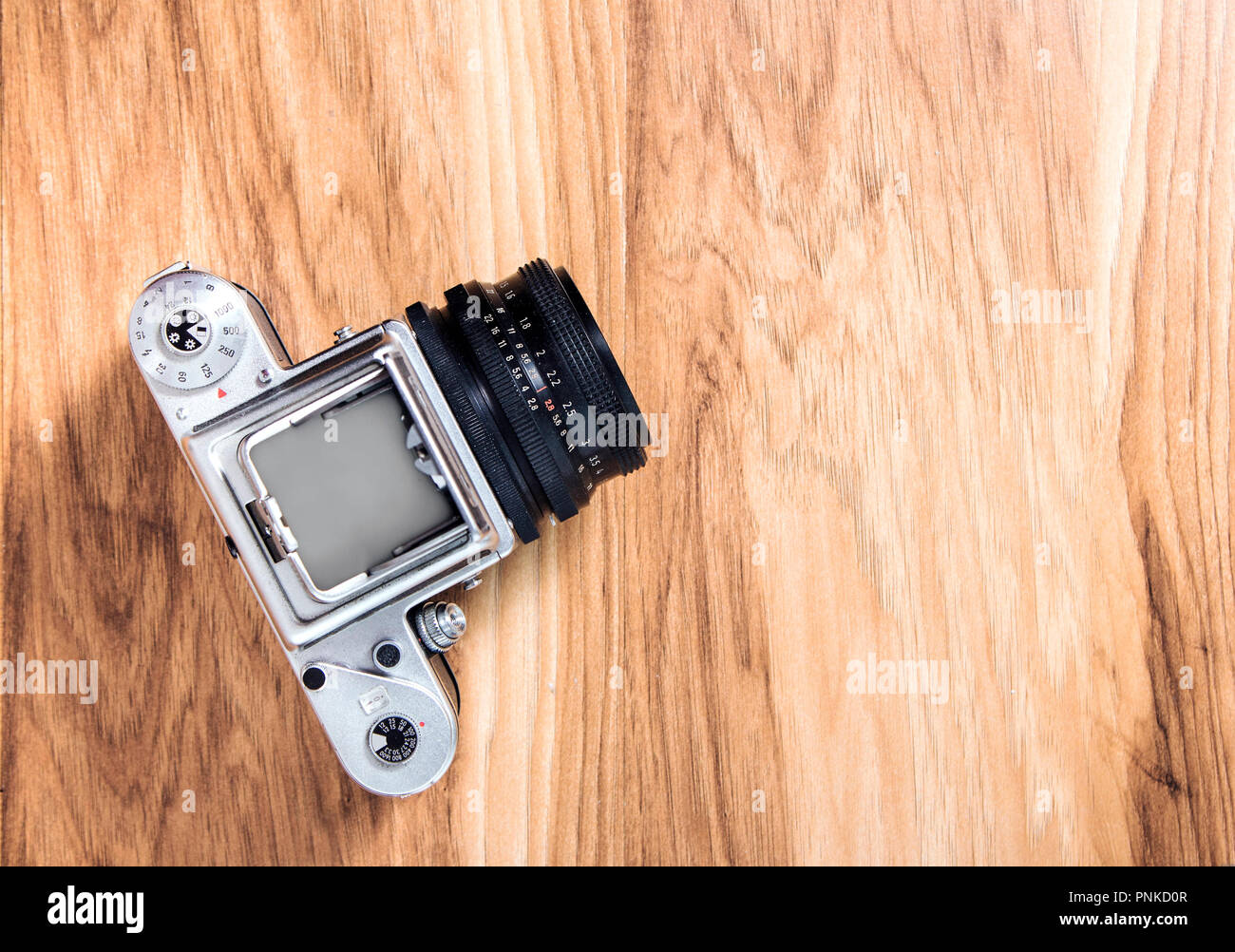 Old medium format camera on natural wooden table Stock Photo - Alamy