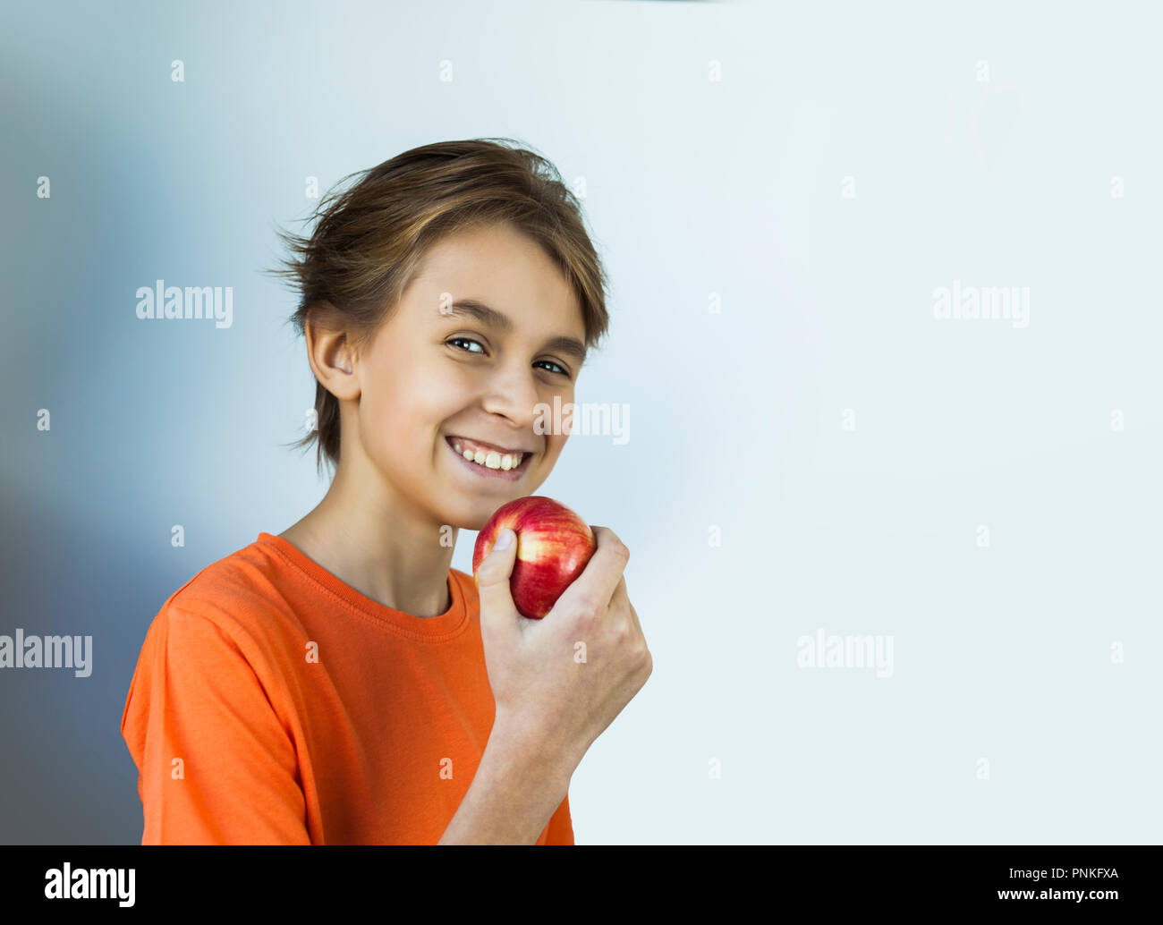 Boy eating apple white background hi-res stock photography and images ...
