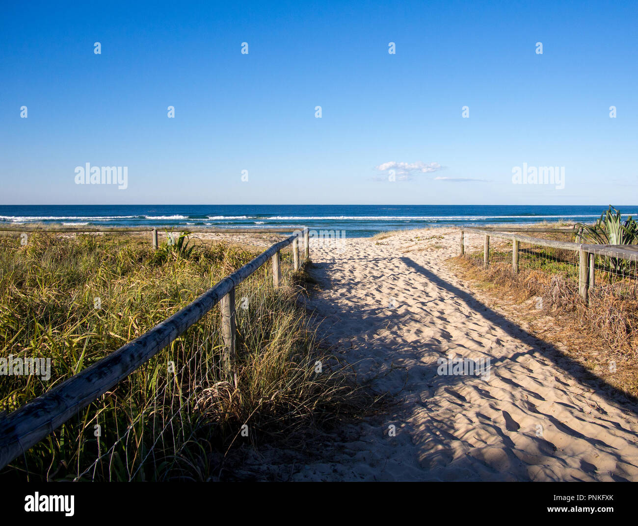 Sandy pathway entrance to the beach with wooden rails Gold Coast ...