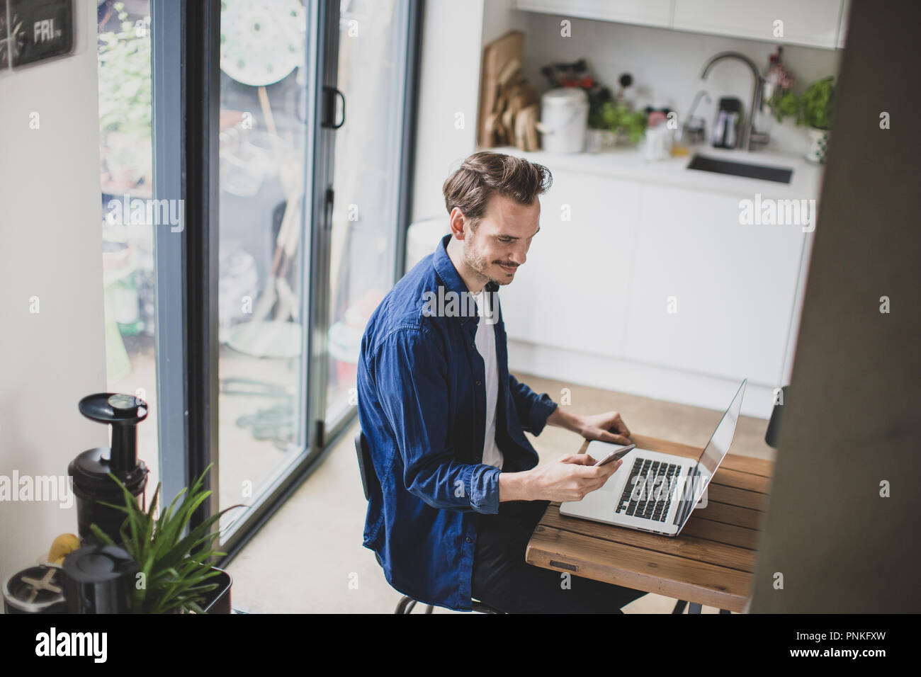 Working in kitchen hi-res stock photography and images - Alamy