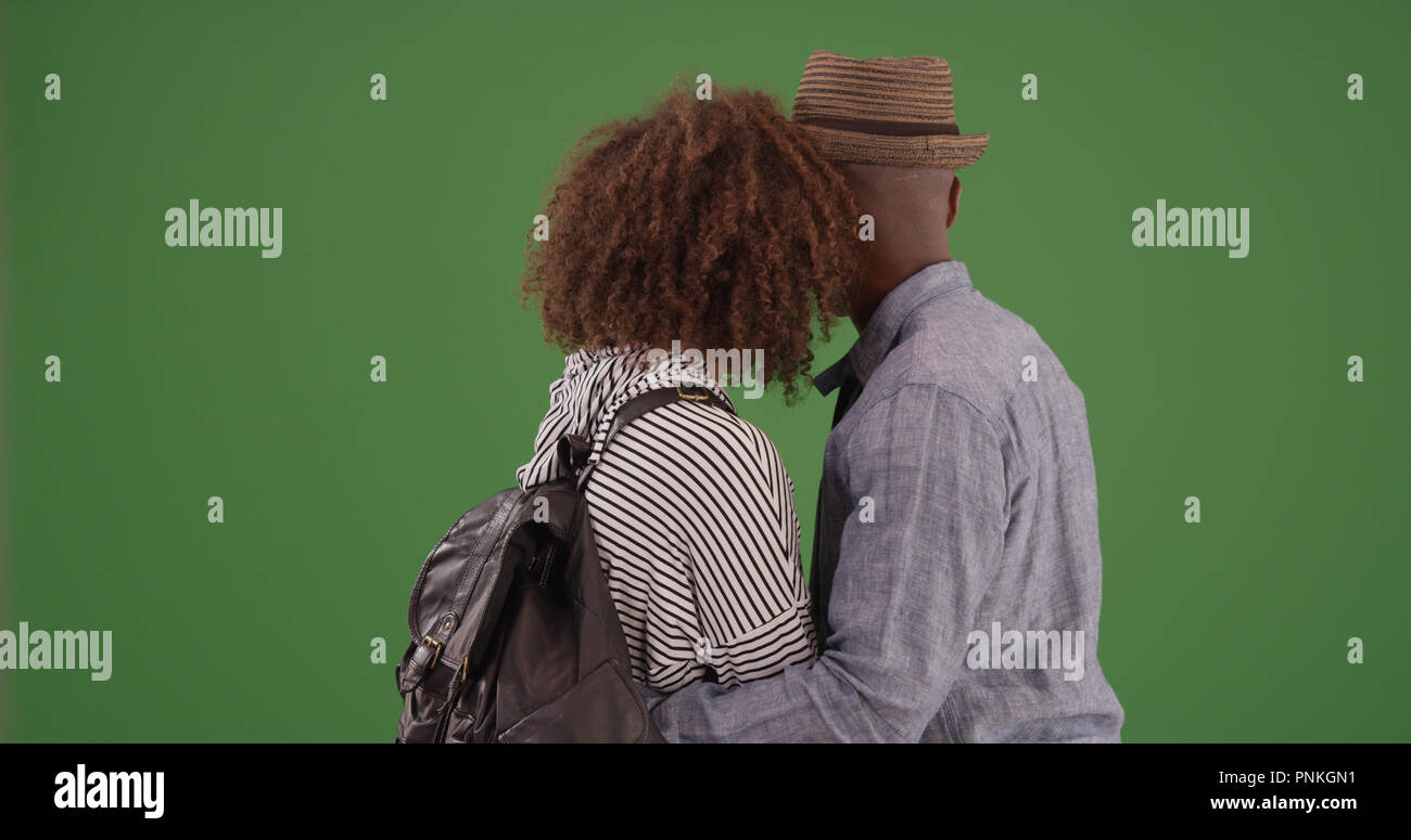 Black couple embracing and staring off into distance on green screen ...