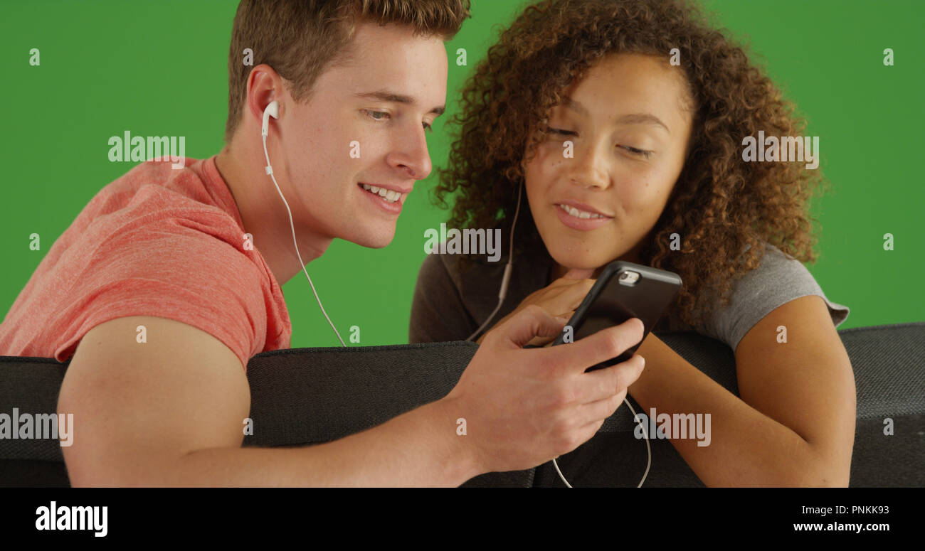 Couple sharing earbuds hi-res stock photography and images - Alamy