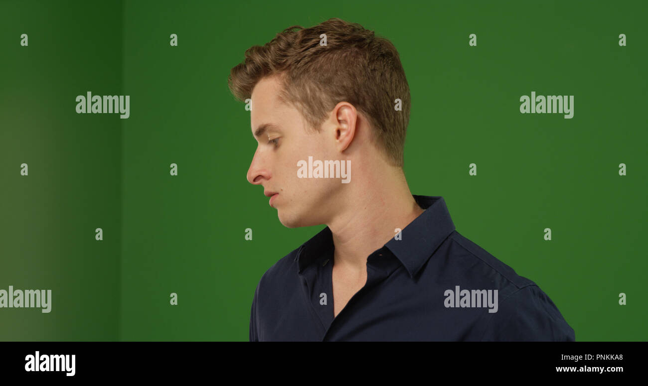 Unhappy looking white millennial male alone on green screen Stock Photo ...