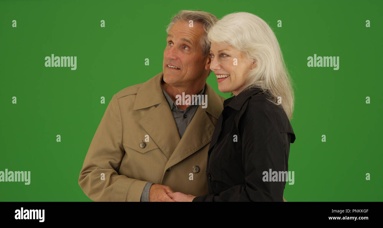 Sweet old couple standing together happily on green screen Stock Photo ...