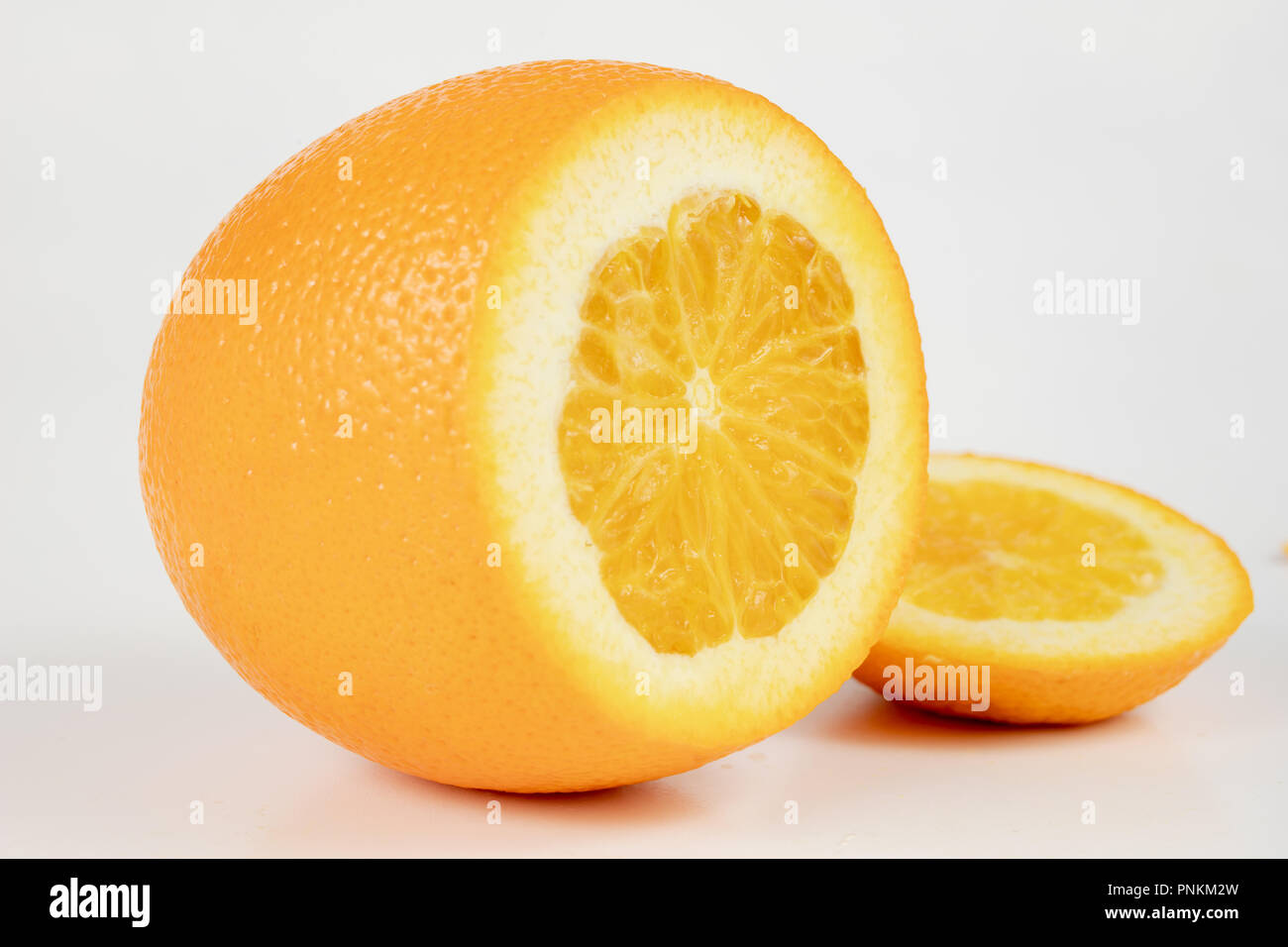 Peeled orange with very thick skin on a white kitchen table. Citruses ...