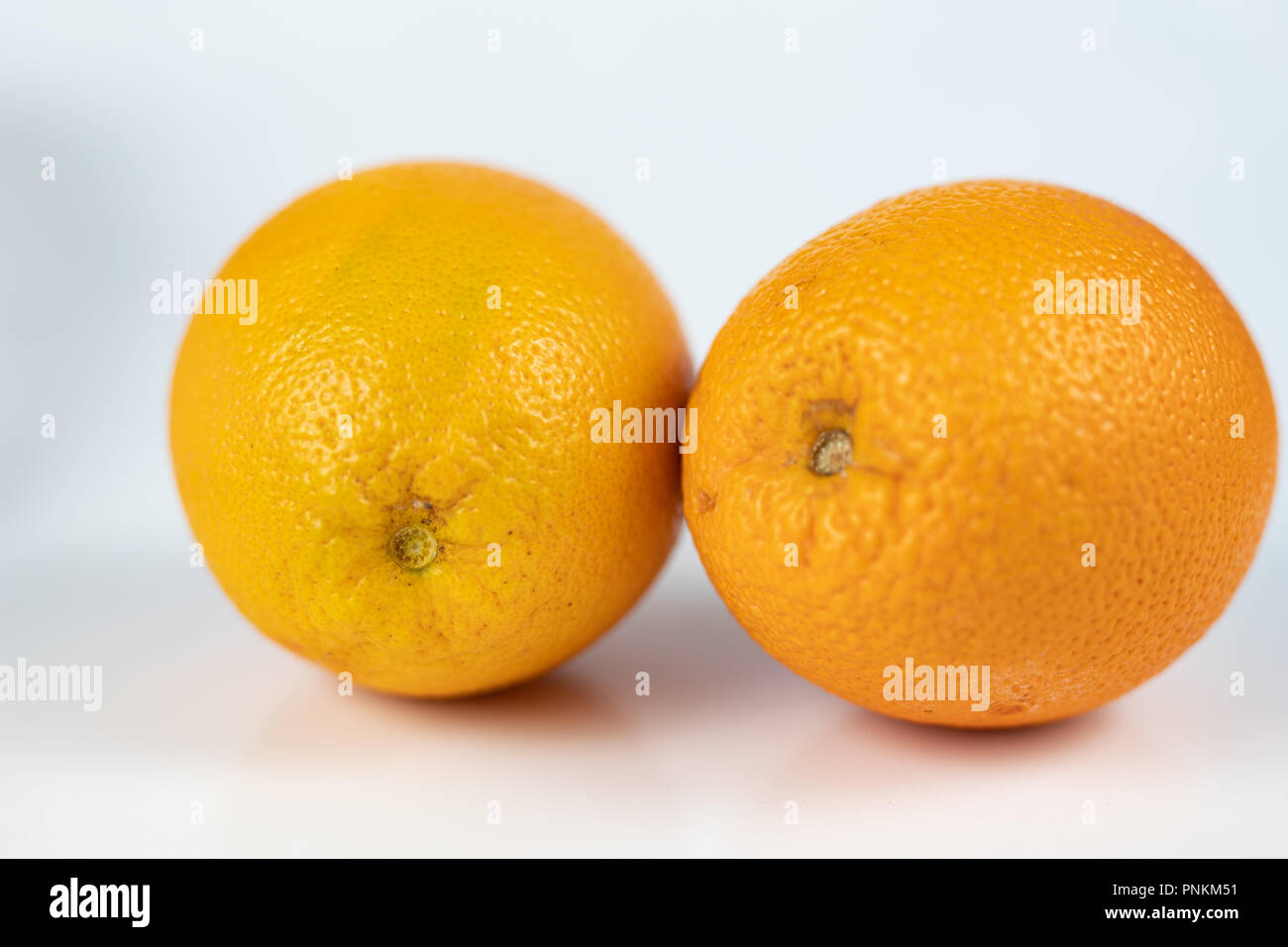 Peeled orange with very thick skin on a white kitchen table. Citruses ...