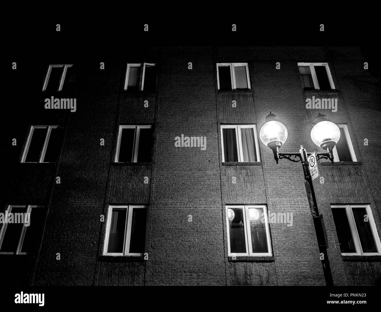 Windows from a building at night in the city illuminated by ...