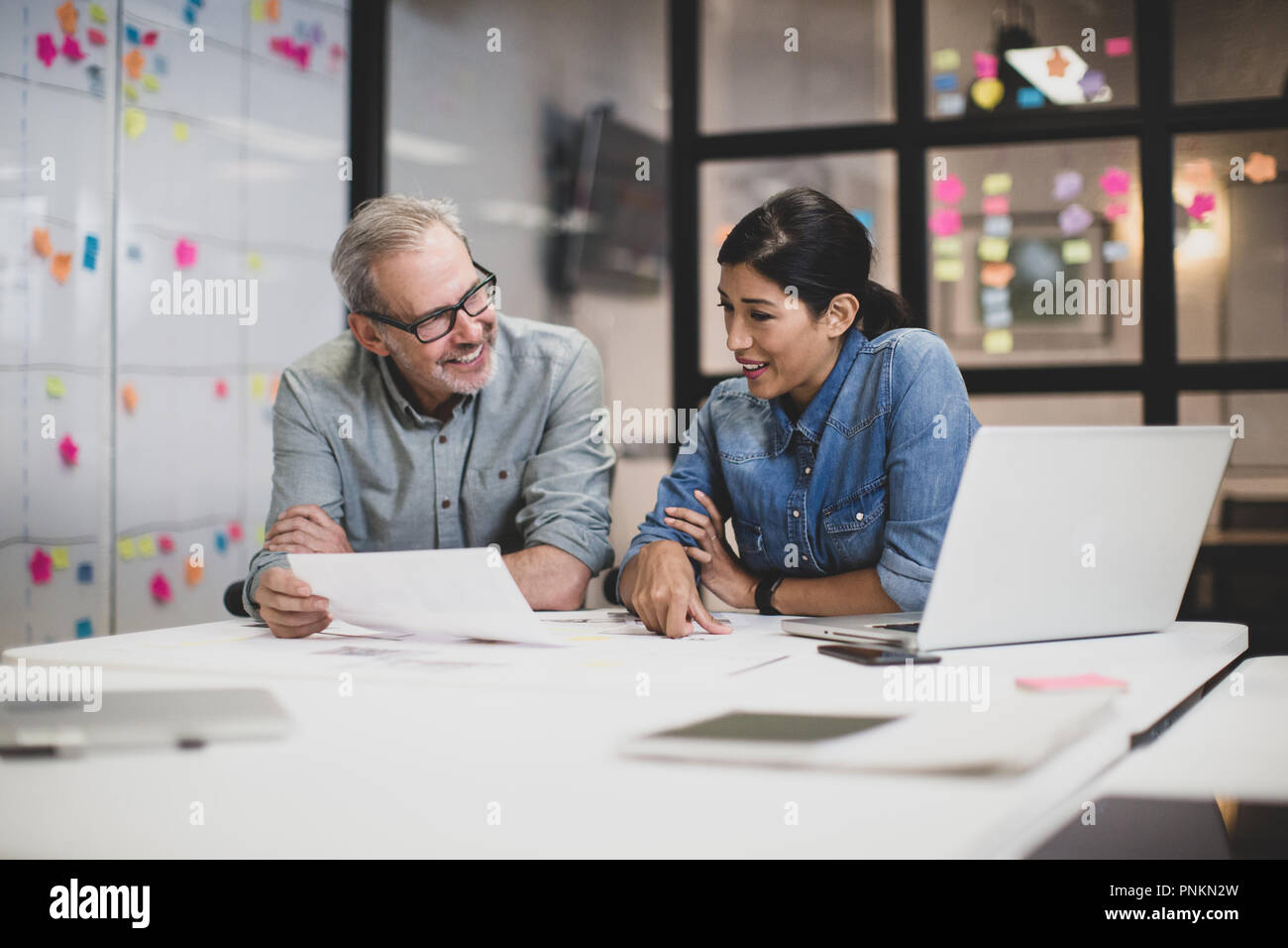 Coworkers in a late meeting Stock Photo - Alamy