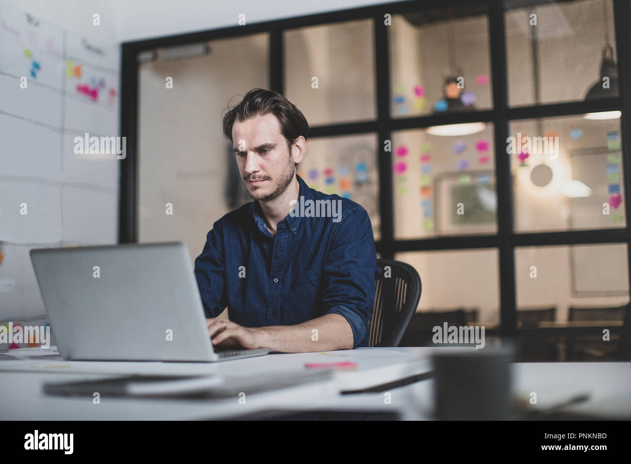 Adult male working late in an office Stock Photo - Alamy