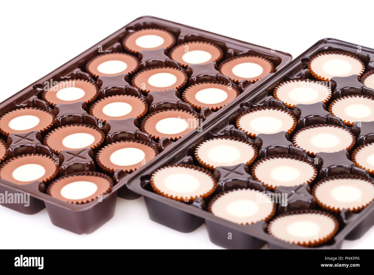 Assortment of chocolate in plastic boxes on white background Stock ...