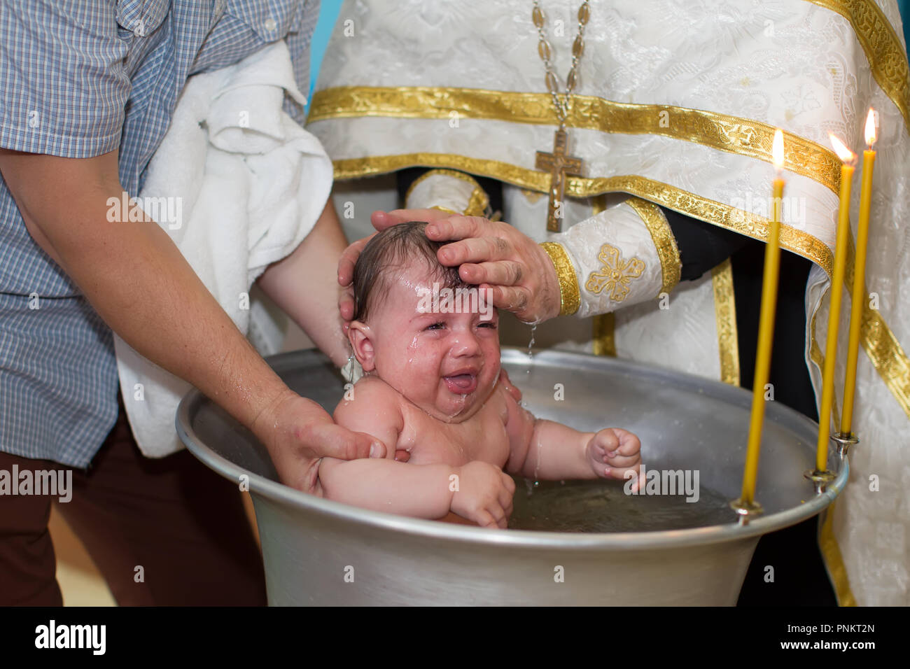Baptism of a child. Ablution in holy water. Accepting faith. Orthodox ...